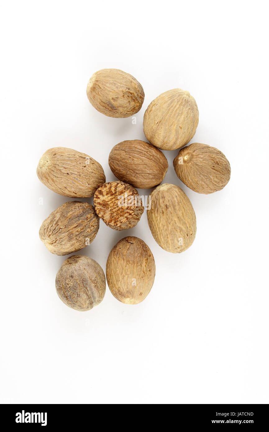 composition of nutmeg seeds isolated on a white background Stock Photo ...