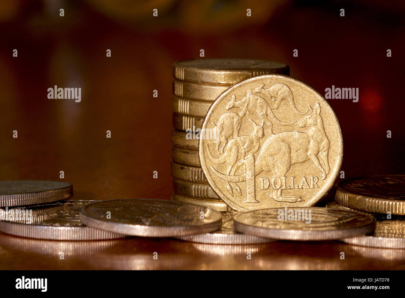 Australian dollar with a stack of coins Stock Photo - Alamy