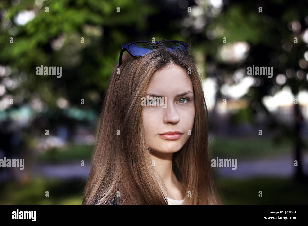 portrait of a young pretty sad girl in the park Stock Photo - Alamy