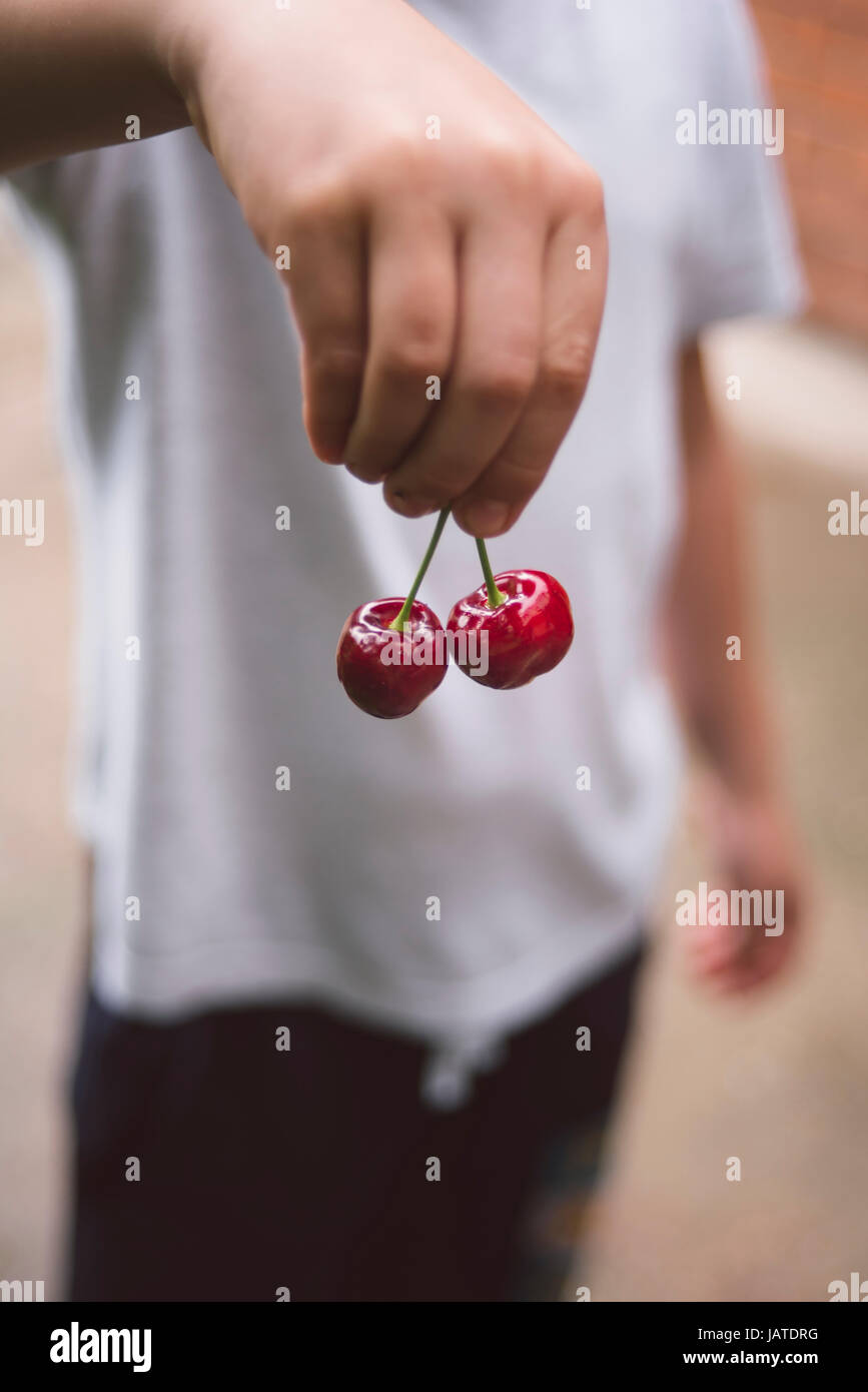 Child hand holding cherry hi-res stock photography and images - Alamy