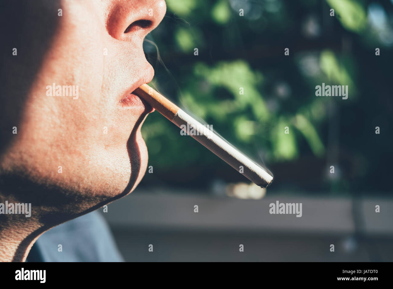 Man smoking a cigarette Stock Photo - Alamy