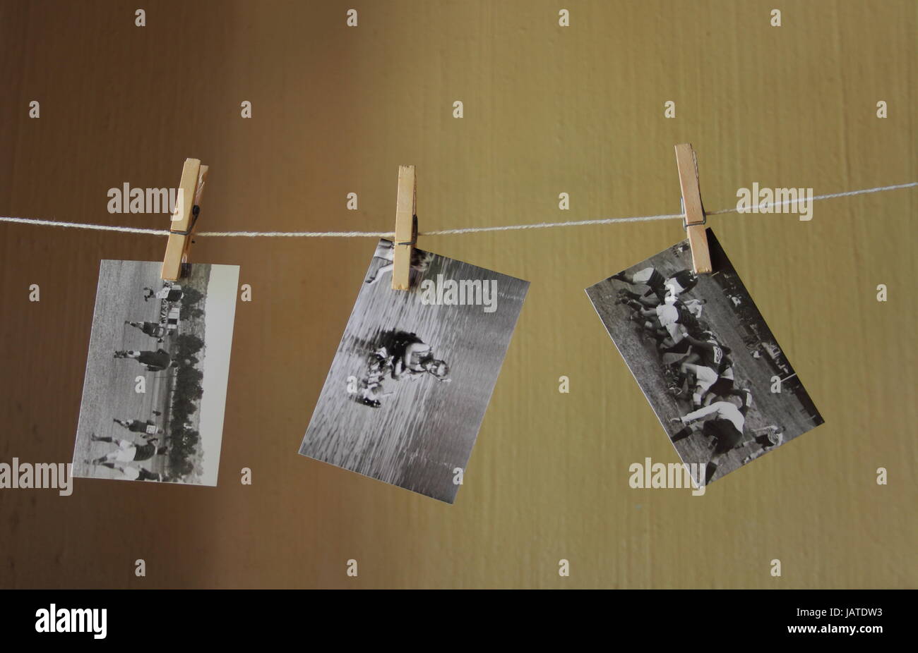 Retro black and white photographs drying on a line after development in ...