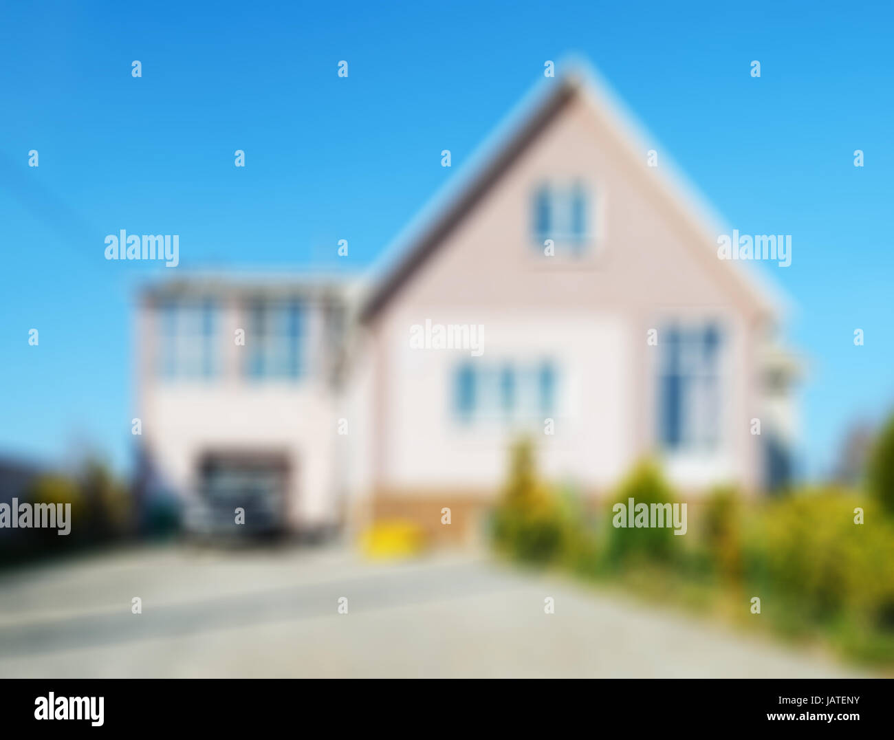 Blur house exterior with a lawn and an entrance to the garage Stock ...