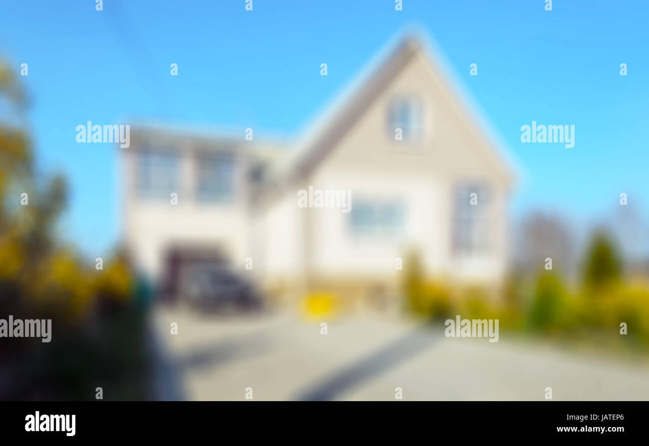 Blur house exterior with a lawn and an entrance to the garage Stock ...