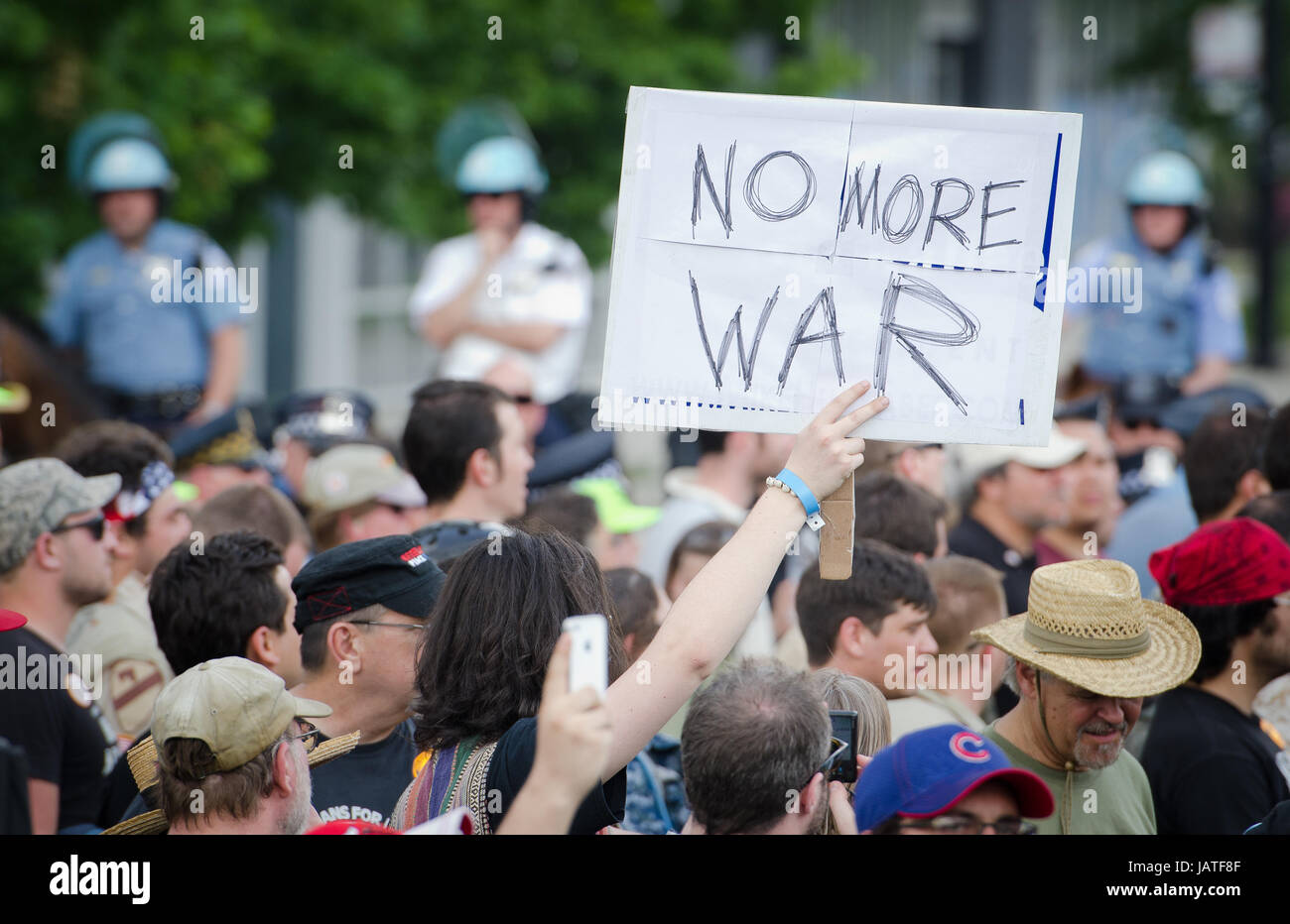 People attending the rally for the Iraq war veterans hold up signs as ...