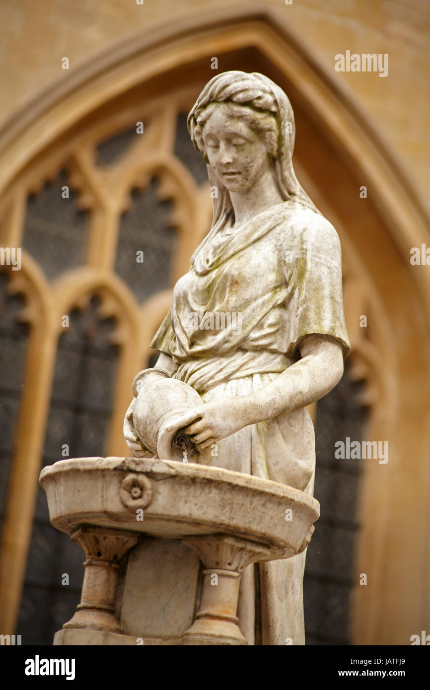 Statue of a woman pouring water outside Bath Abbey Stock Photo - Alamy