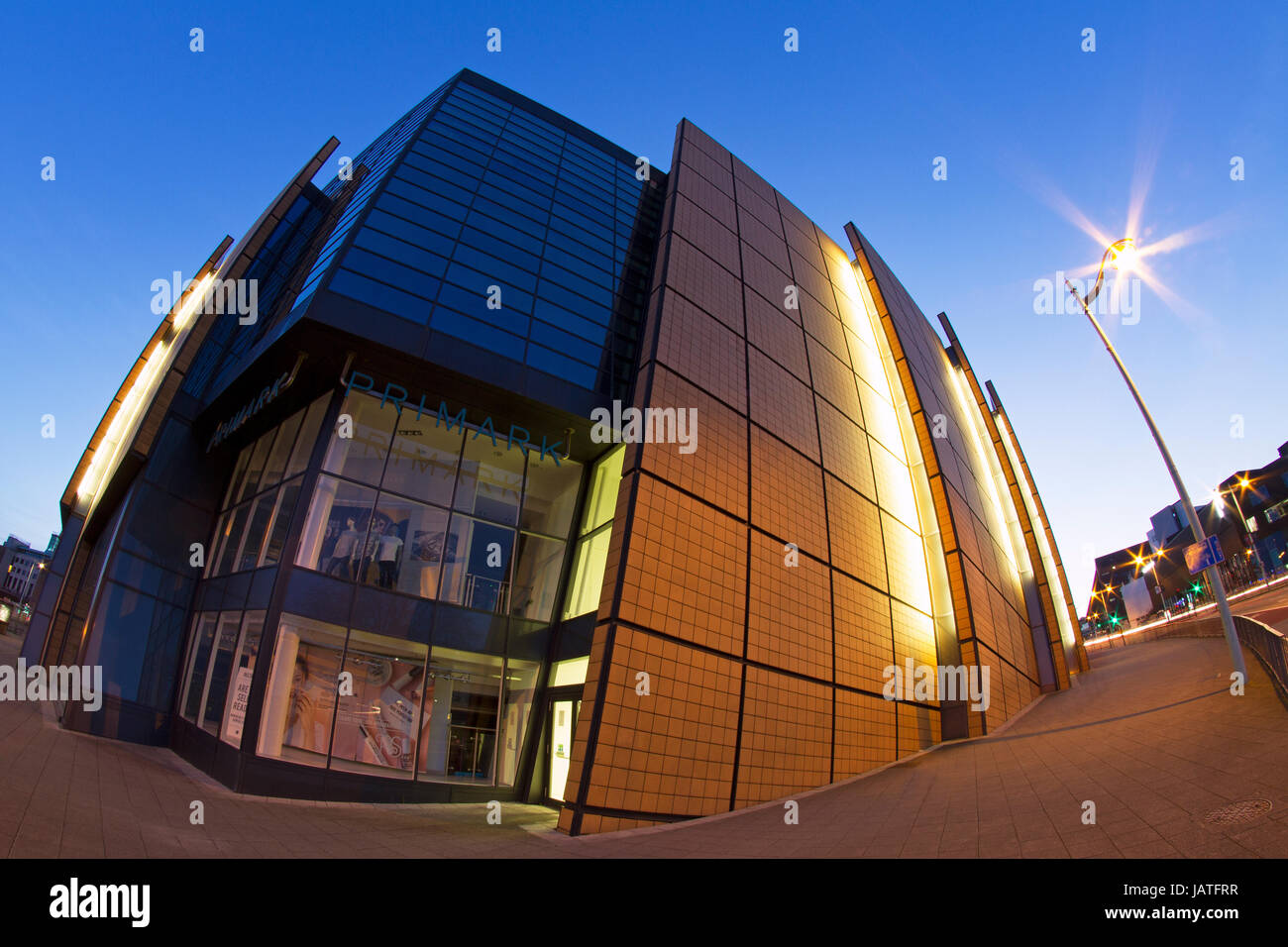 A modern architectural shopping mall in Plymouth city centre at dusk ...
