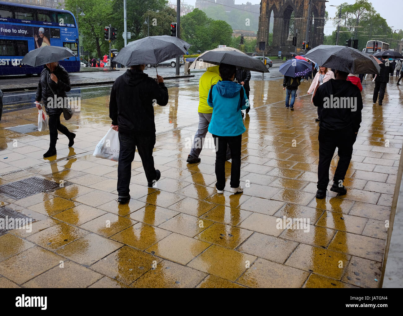 Shoppers in the rain on Princess street Edinburgh Stock Photo - Alamy