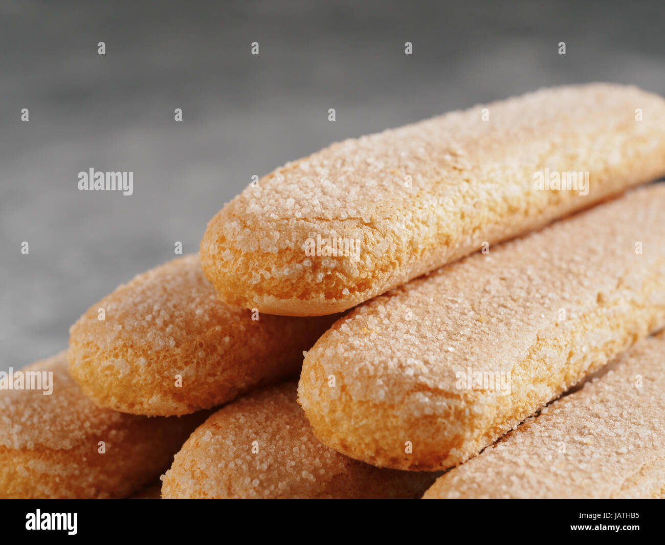 Close up view of ladyfinger biscuit cookie on gray concrete background ...