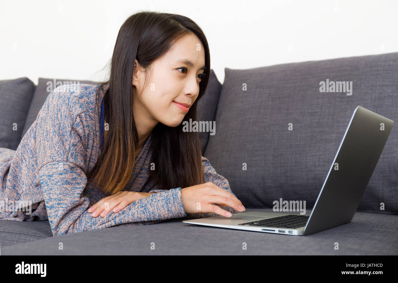Asian woman using computer at home Stock Photo - Alamy