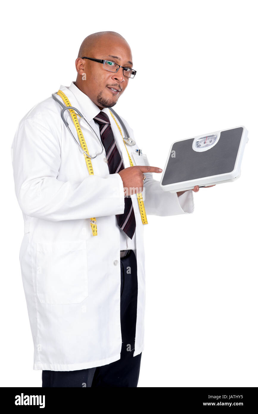 Dark doctor posing with weight scale and measuring tape Stock Photo - Alamy