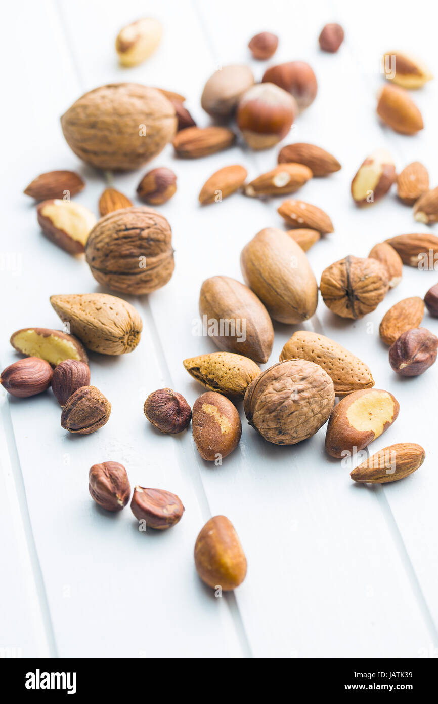 Mixed nuts on white table Stock Photo - Alamy