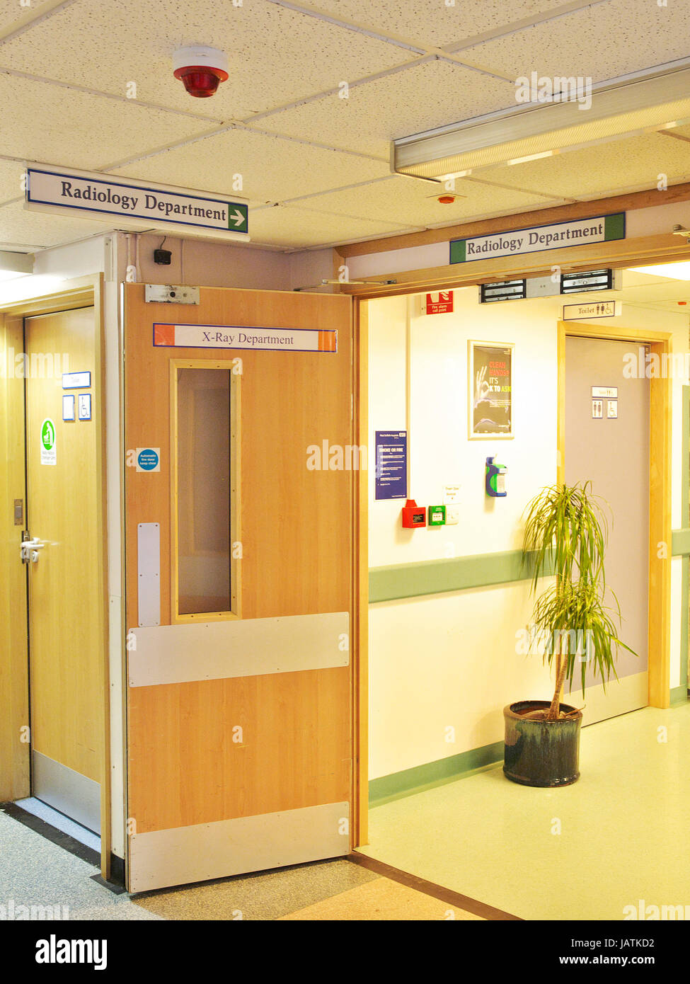NHS Hospital signage in UK hospital with patient blur through doorways ...