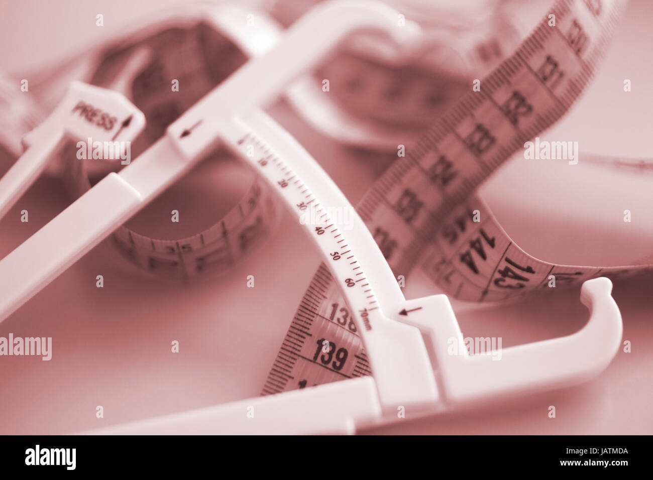 Fat caliper and measuring tape used to measure waistline, bodyfat ...