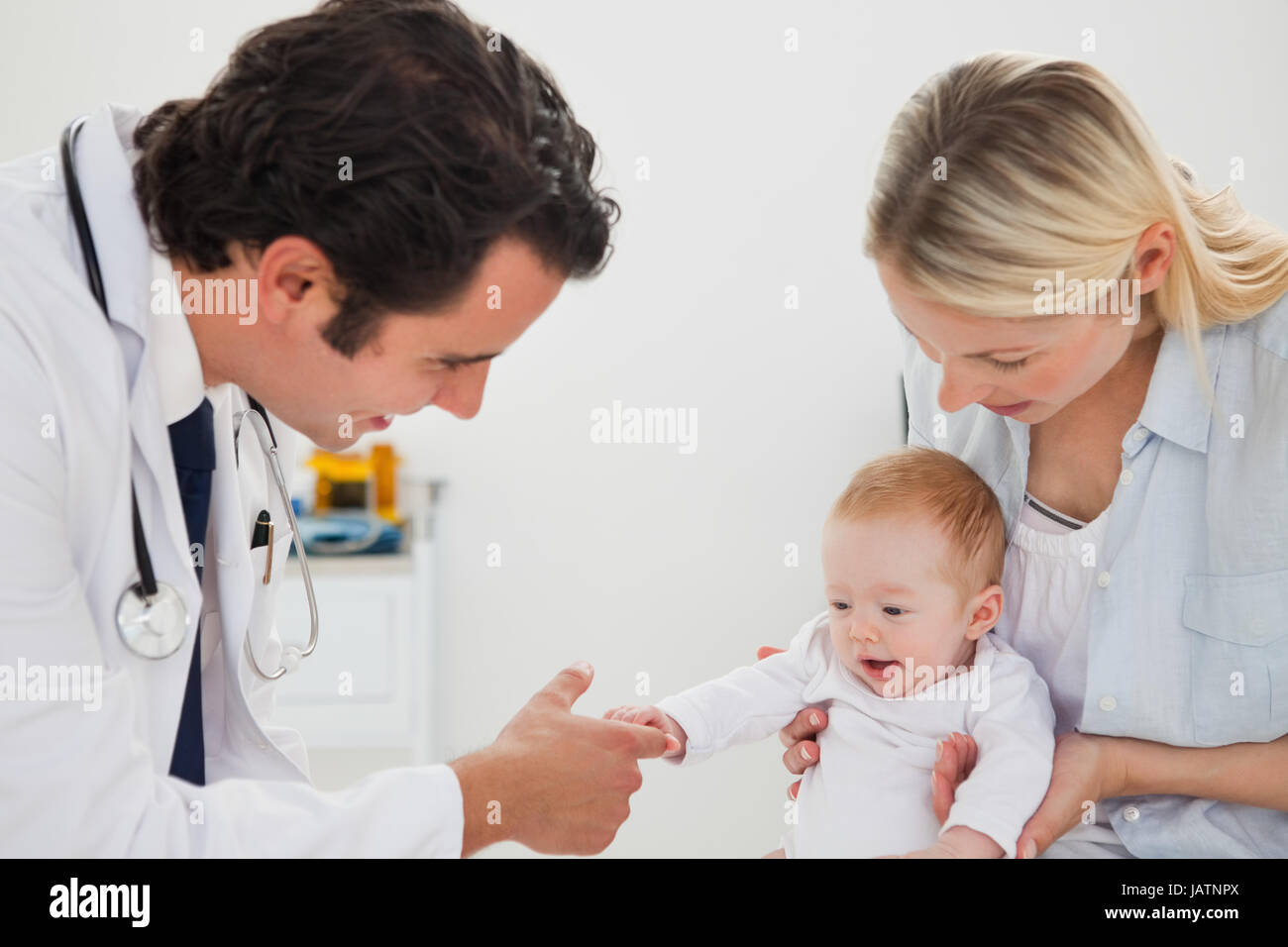 Baby grabbing doctors finger Stock Photo - Alamy