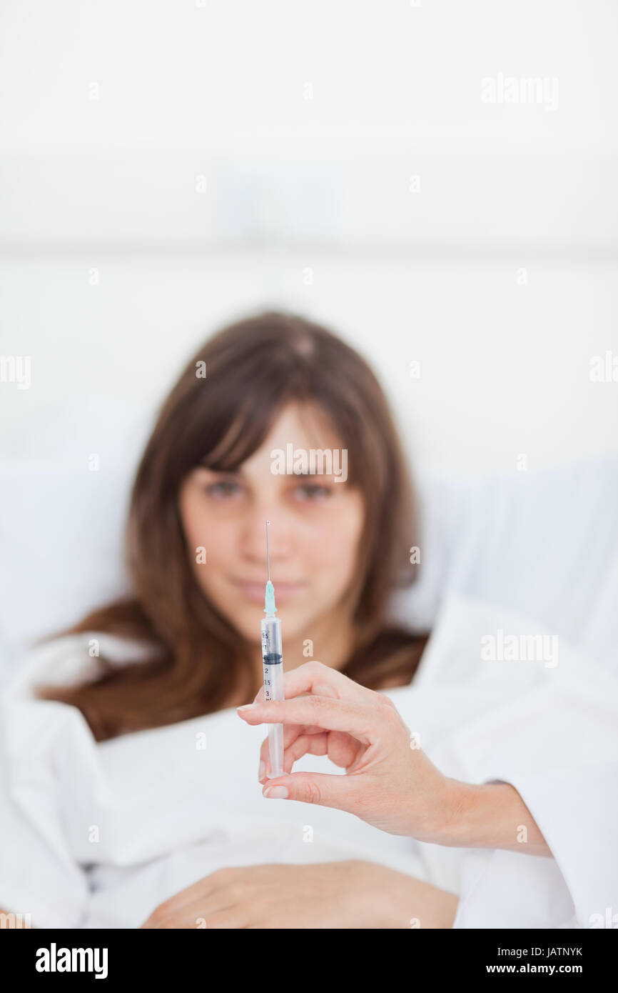 Syringe being shown to a patient Stock Photo - Alamy