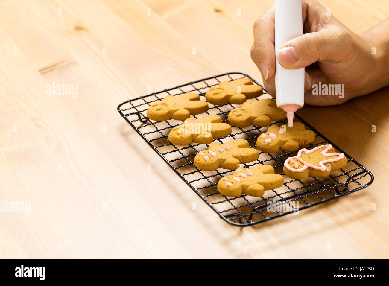 Gingerbread with icing decorating process Stock Photo - Alamy