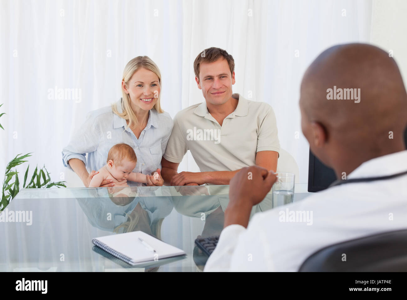 Family with their baby seeing the doctor Stock Photo - Alamy