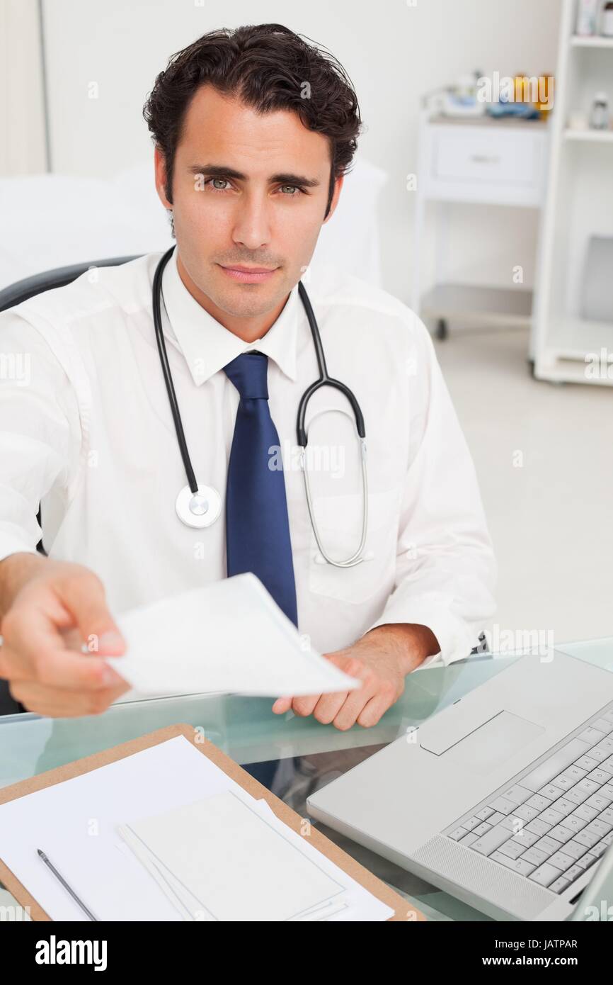 Doctor handing over a prescription Stock Photo - Alamy
