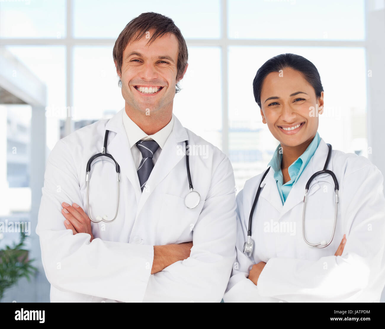 Smiling doctors standing together while looking at the camera Stock ...