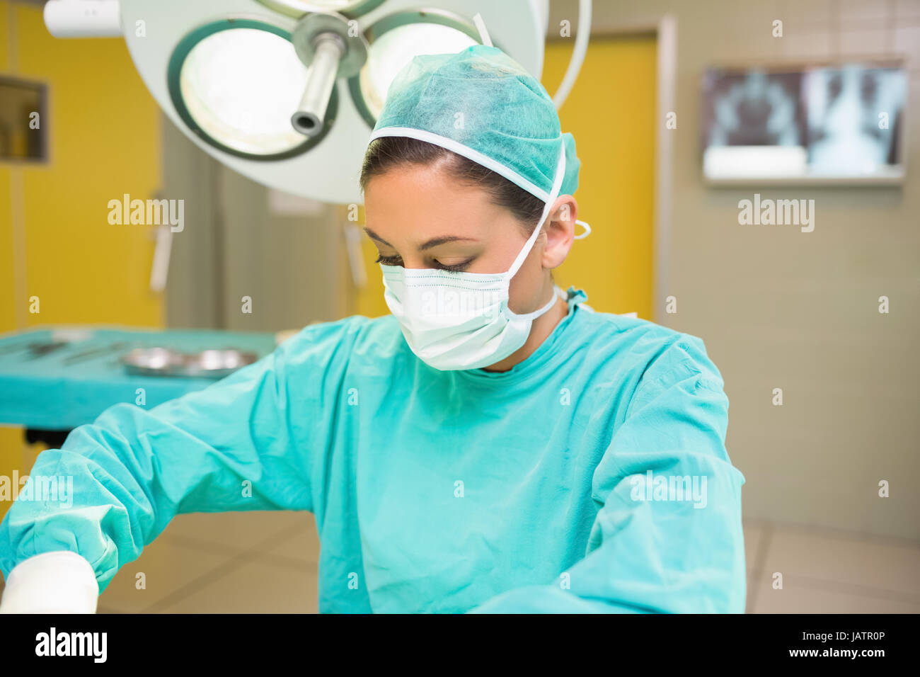 Concentrated female surgeon in operating theater Stock Photo - Alamy