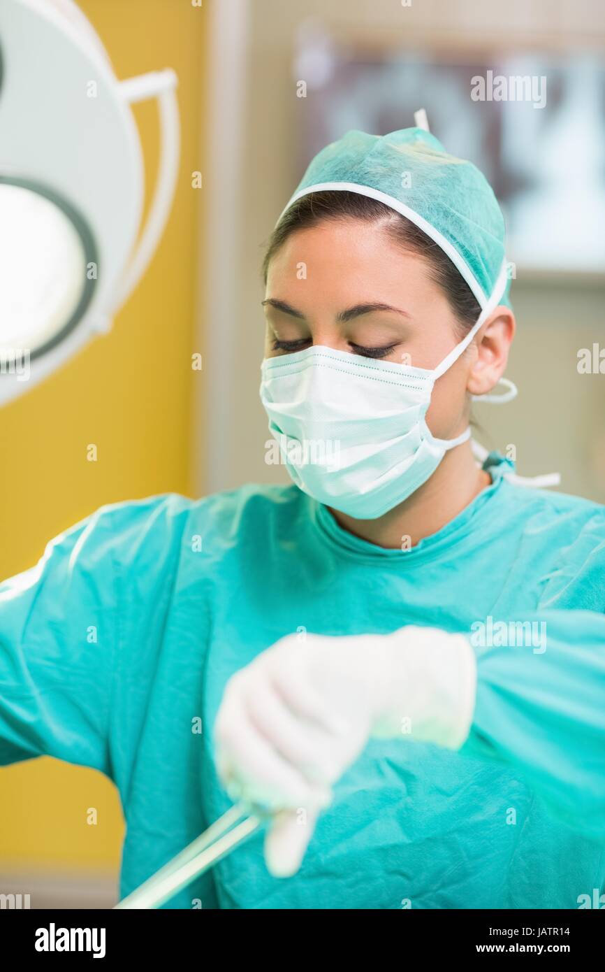 Concentrated female surgeon using surgical tools Stock Photo - Alamy