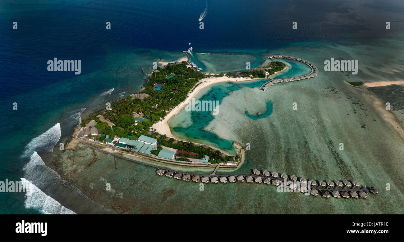 Small island in Maldives with typical resorts and bungallow on it ...