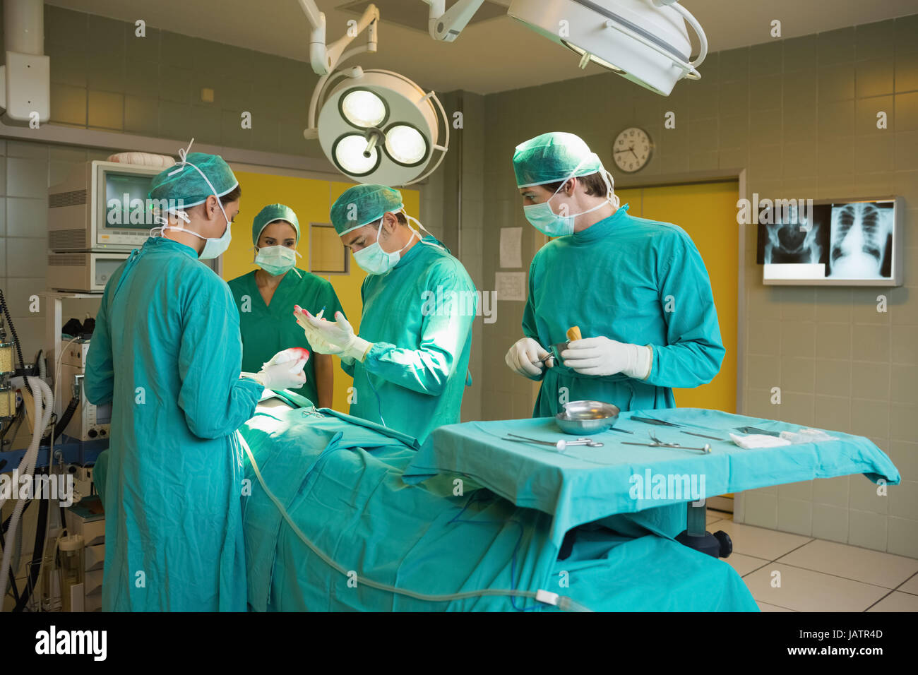 Surgeon team operating in an operating theatre Stock Photo - Alamy