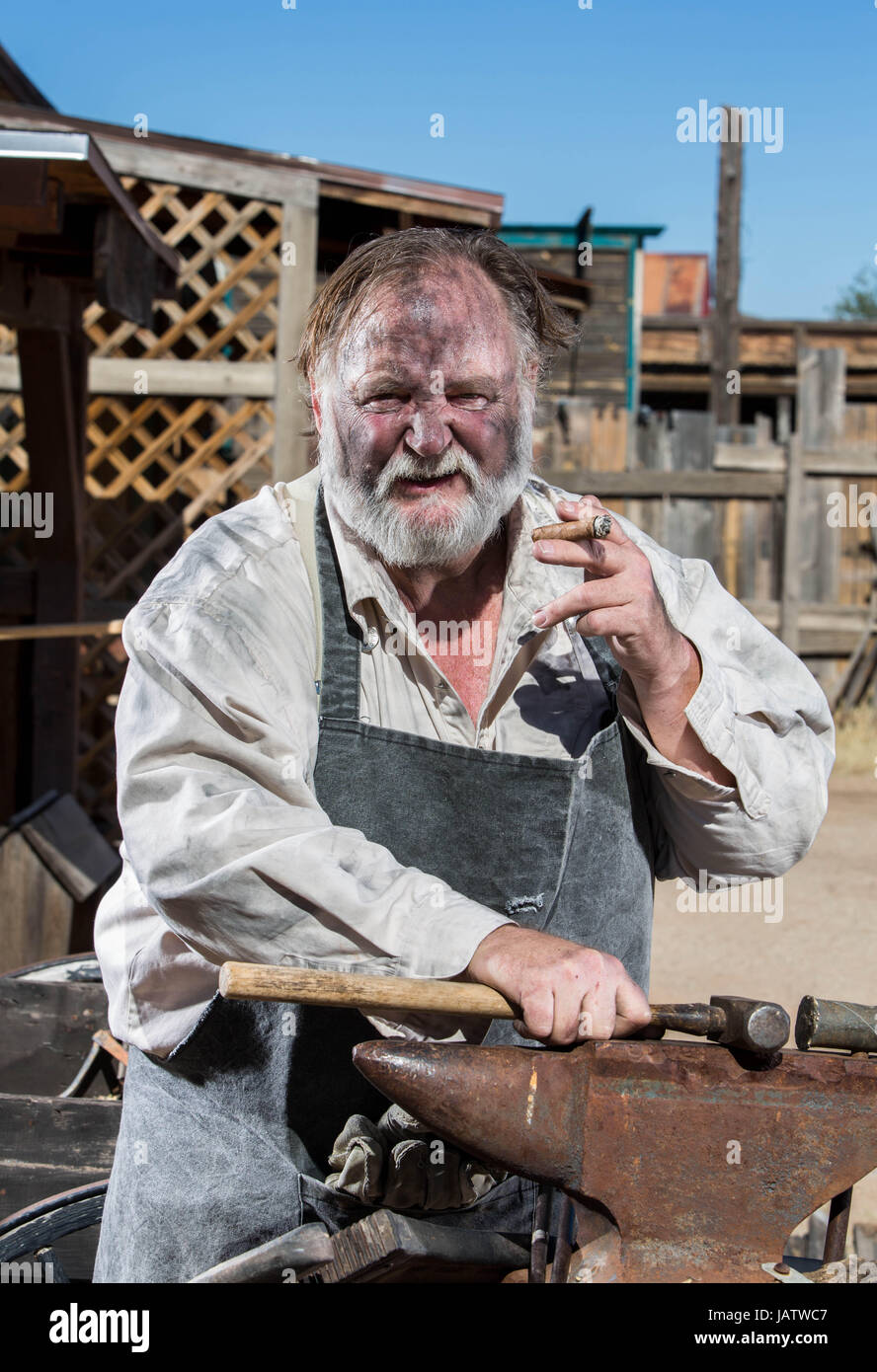 Old West Blacksmith Smokes a Cigar Stock Photo - Alamy
