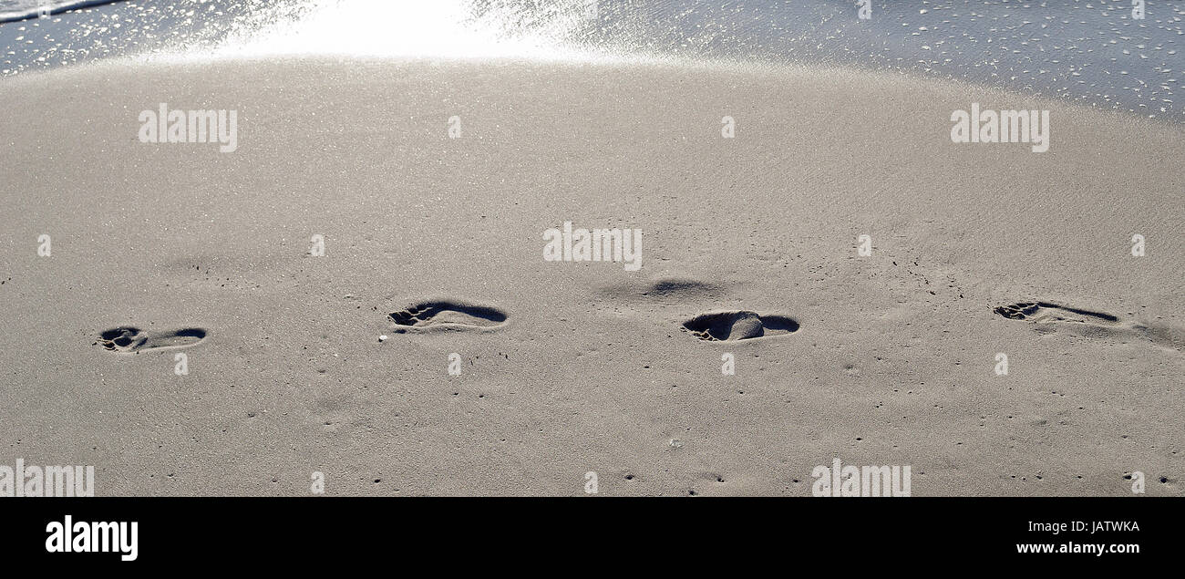 four footsteps in the sand Stock Photo - Alamy