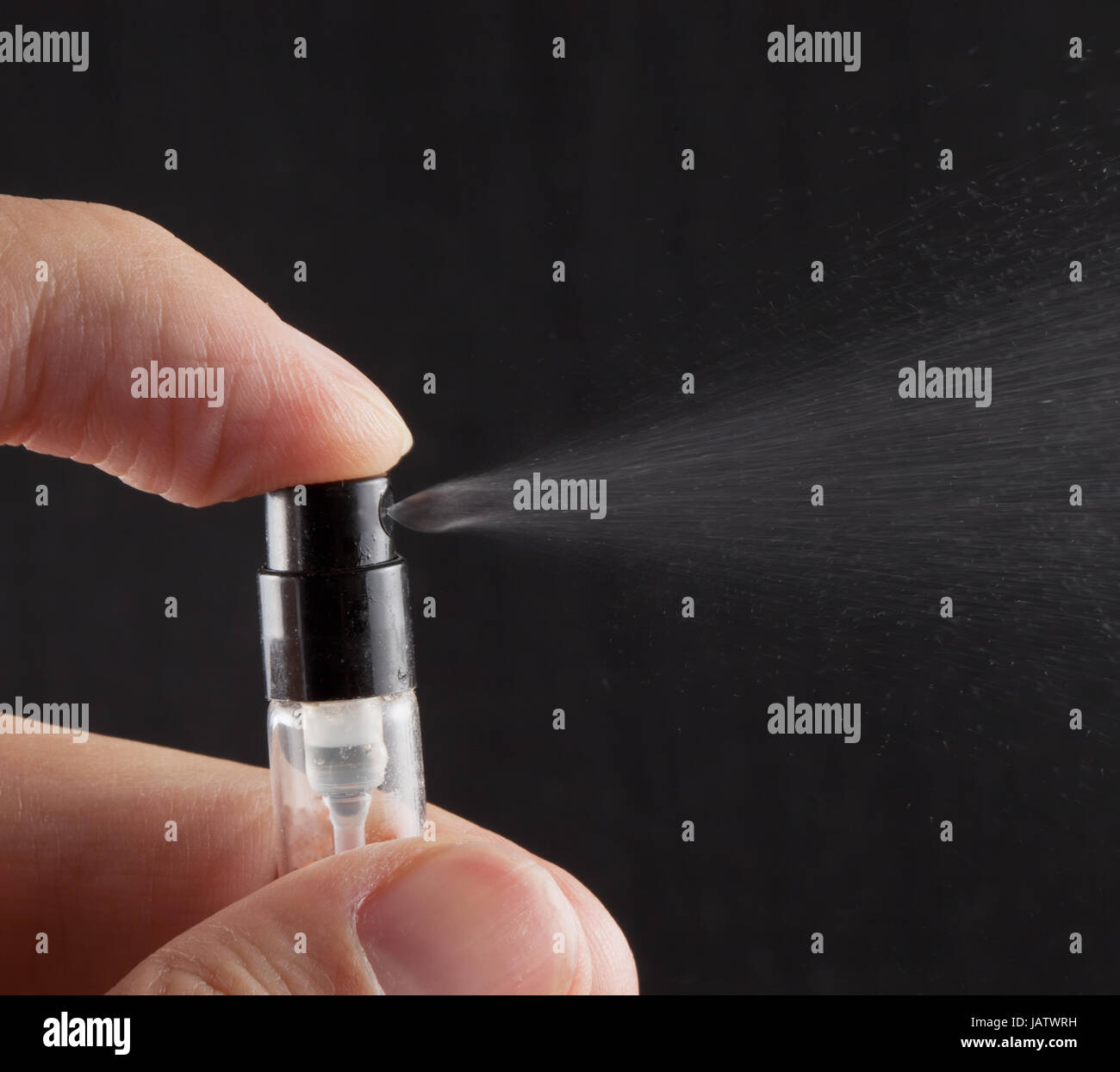 Male hand pushing on a little spray perfume Stock Photo - Alamy