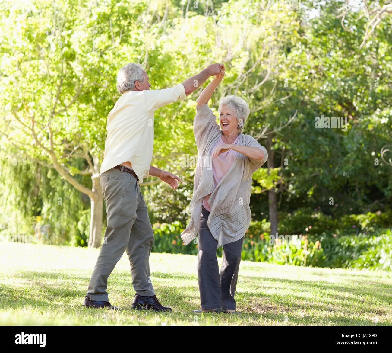 Man twirling a woman in a park Stock Photo - Alamy
