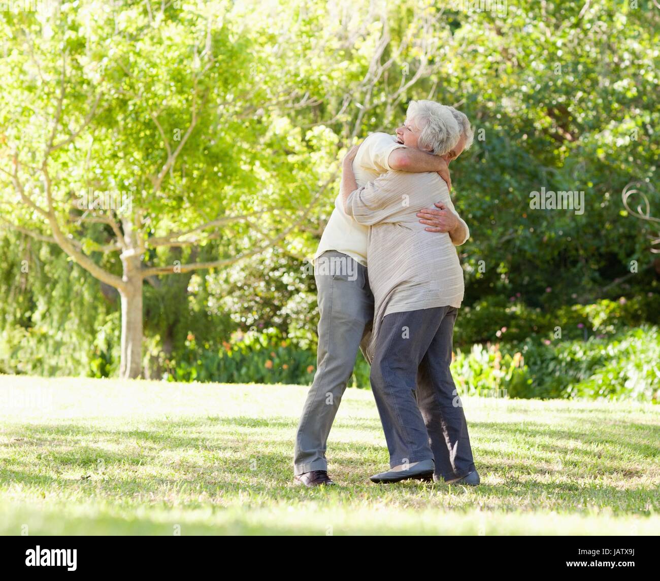 Two friends hugging each other in a park Stock Photo - Alamy