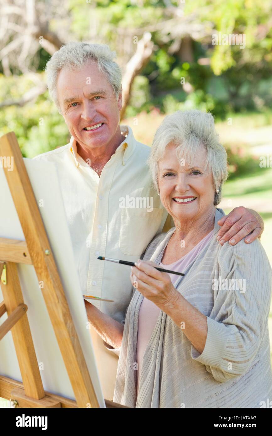 Two friends holding each other while painting Stock Photo - Alamy