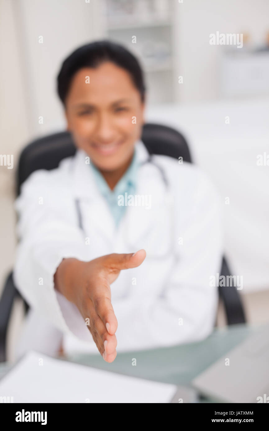 Hand being offered out by a smiling doctor Stock Photo - Alamy