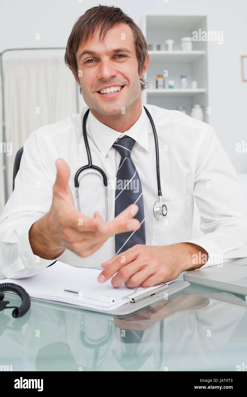 Smiling doctor moving his hands while giving explanations Stock Photo ...