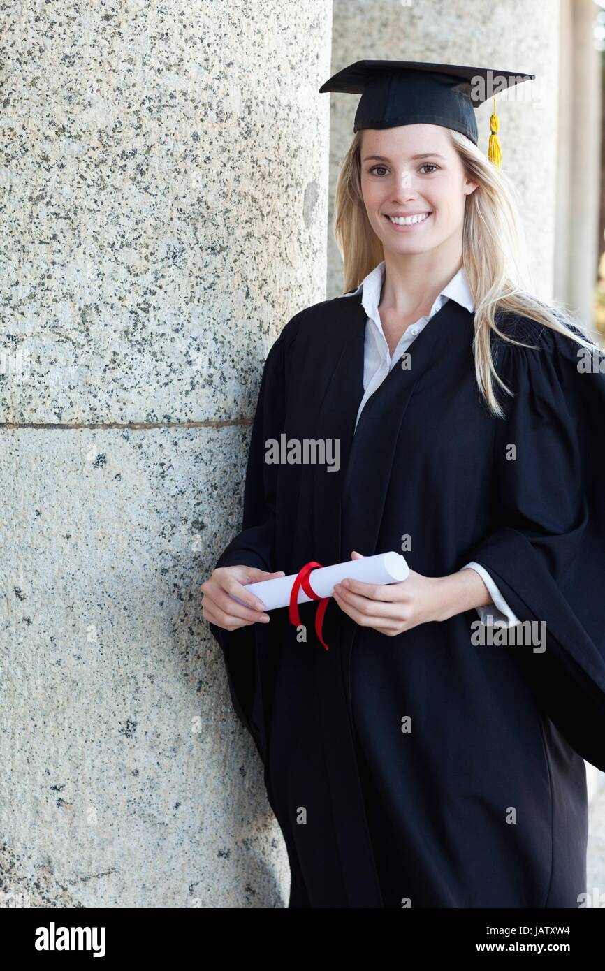 Young smiling graduating student holding her diploma Stock Photo - Alamy