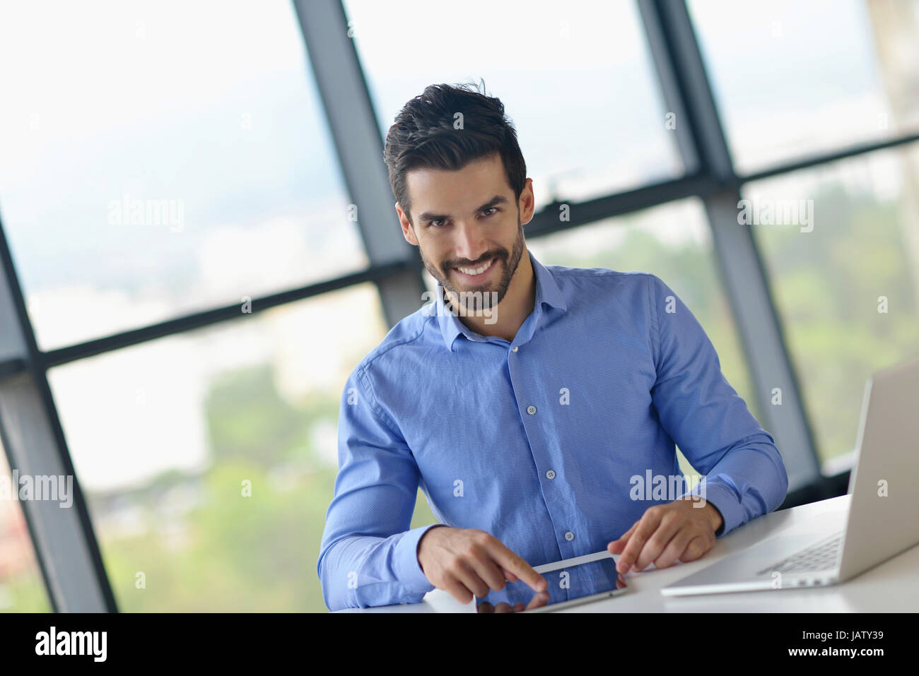 happy young business man work in modern office on computer Stock Photo ...
