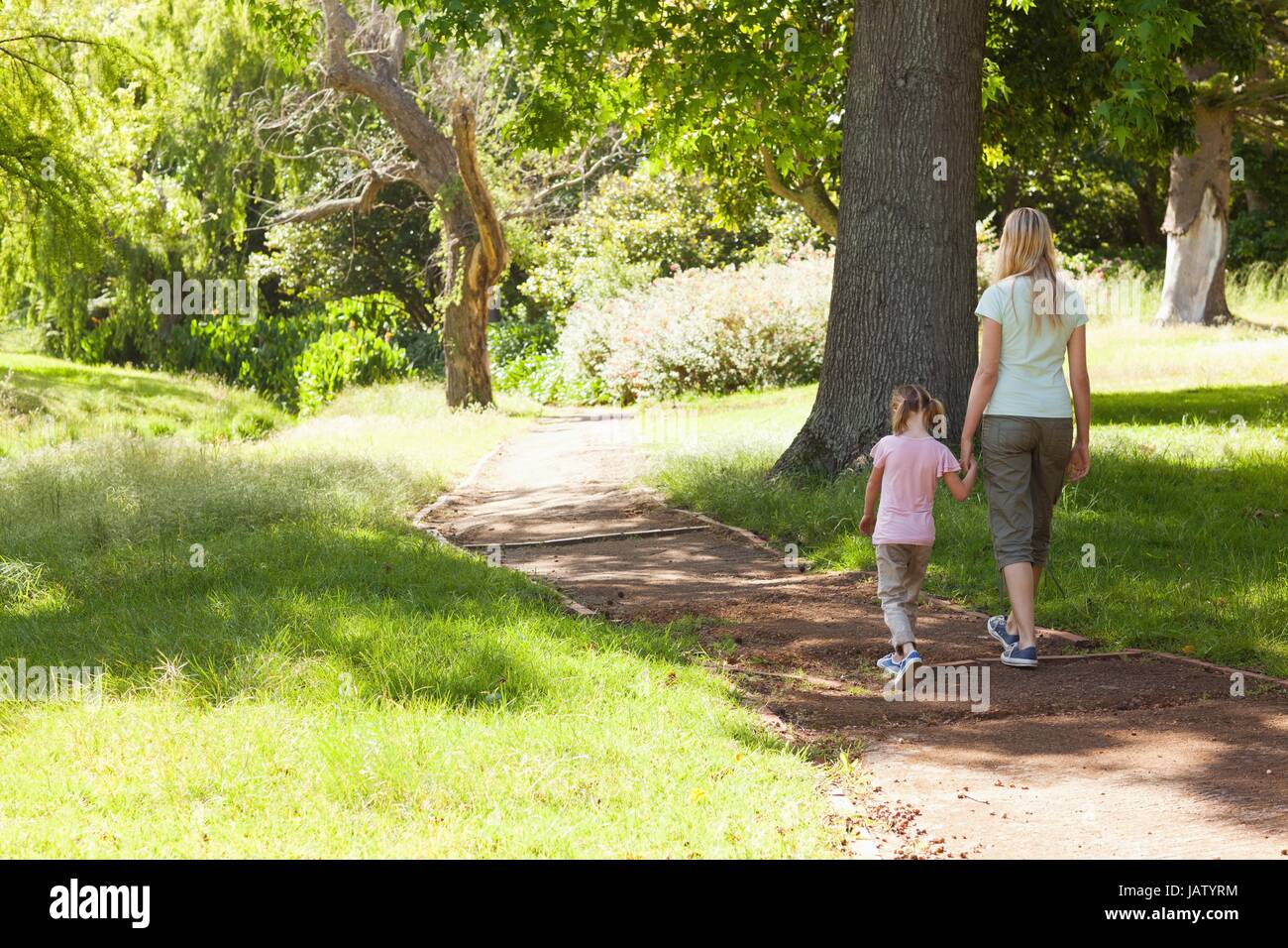 A mother and daughter walking down a path Stock Photo - Alamy