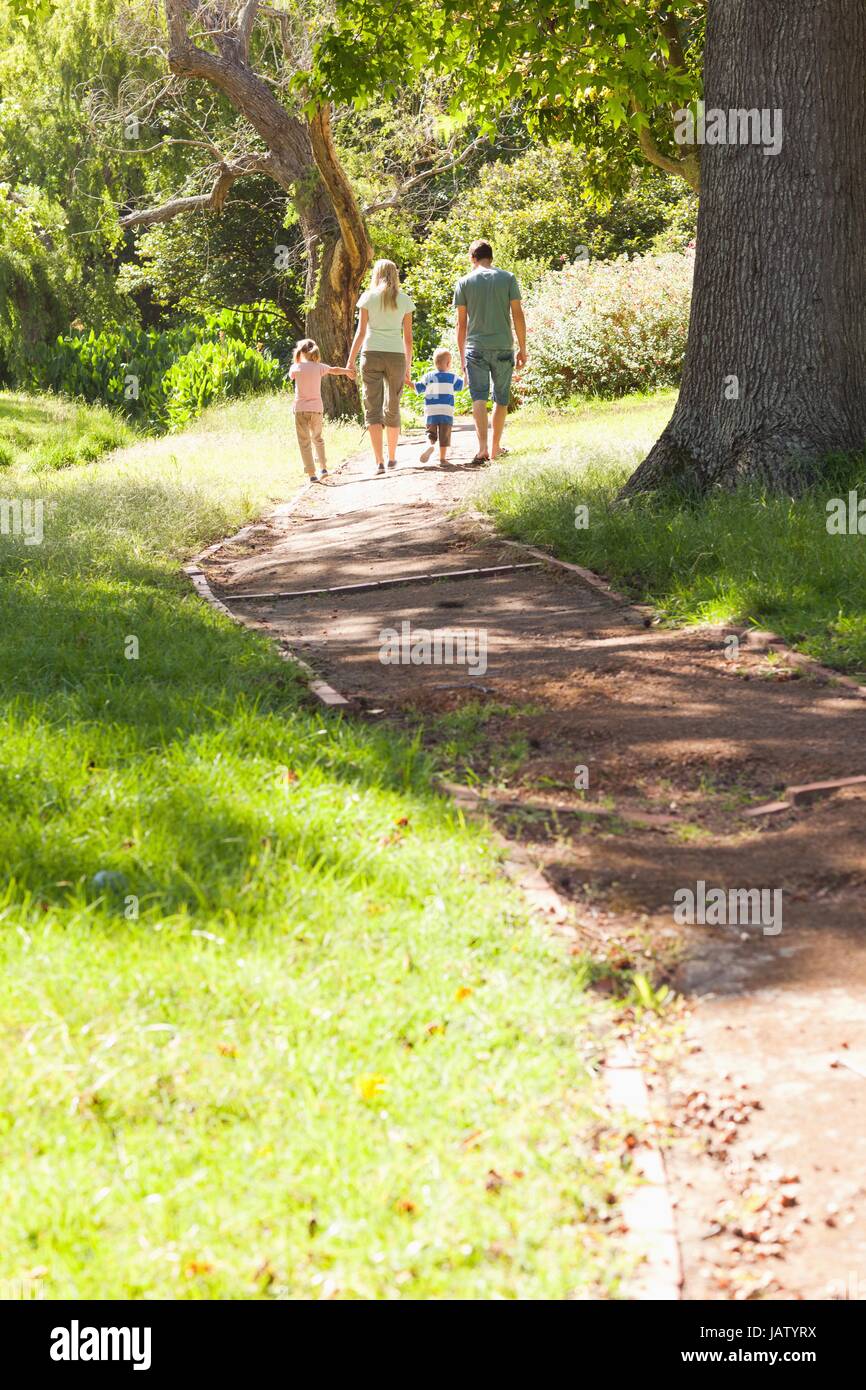 Boy and girl walking down path holding hands hi-res stock photography ...