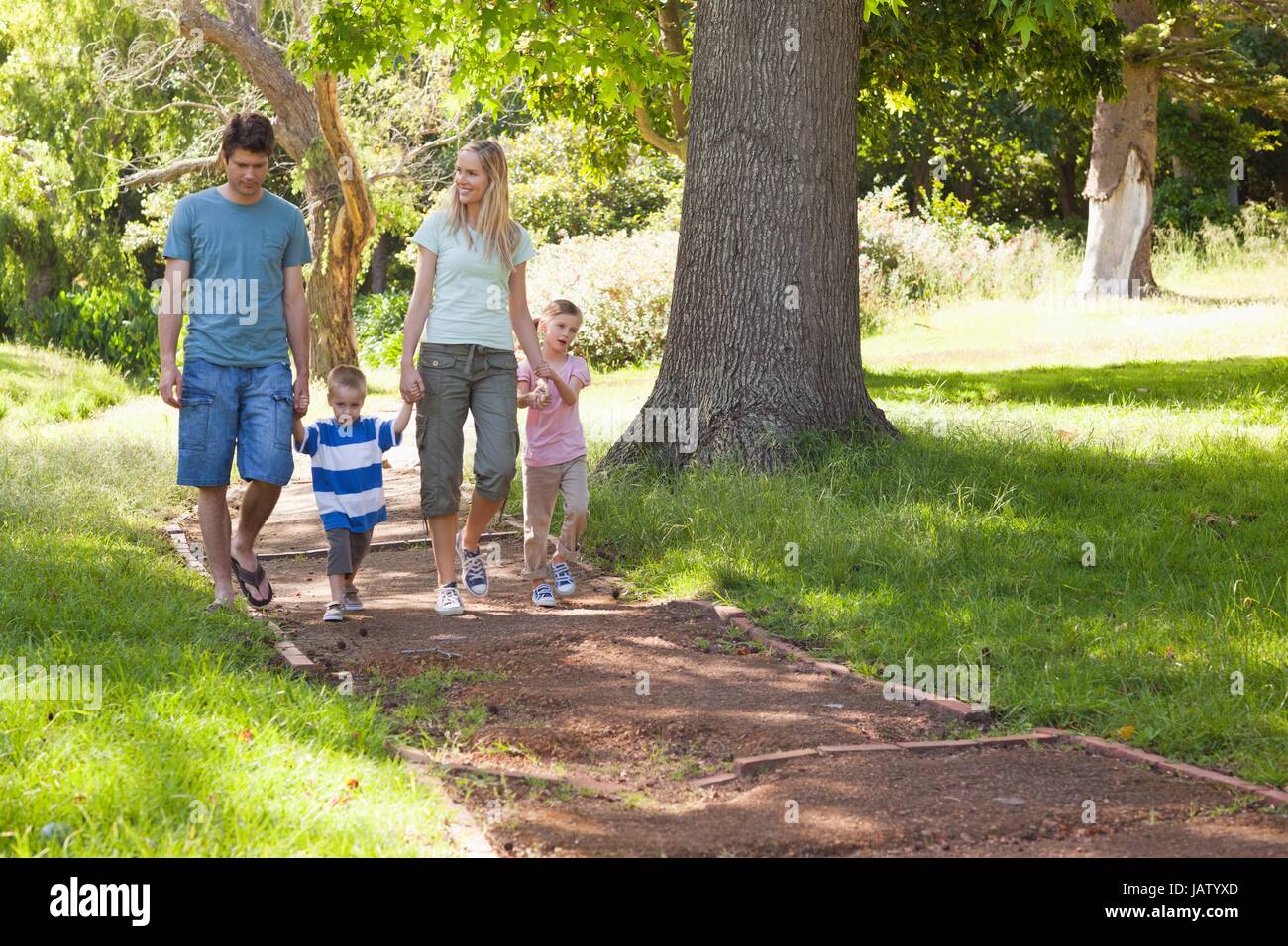 A family walking towrds the camera getting closer Stock Photo - Alamy
