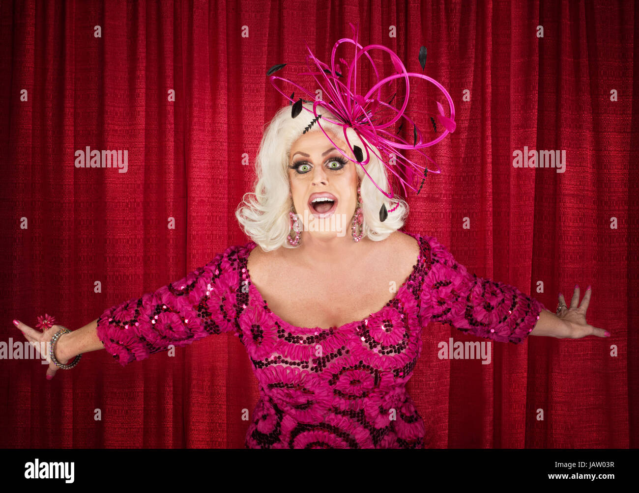 Happy drag queen in blond with singing in theater Stock Photo - Alamy
