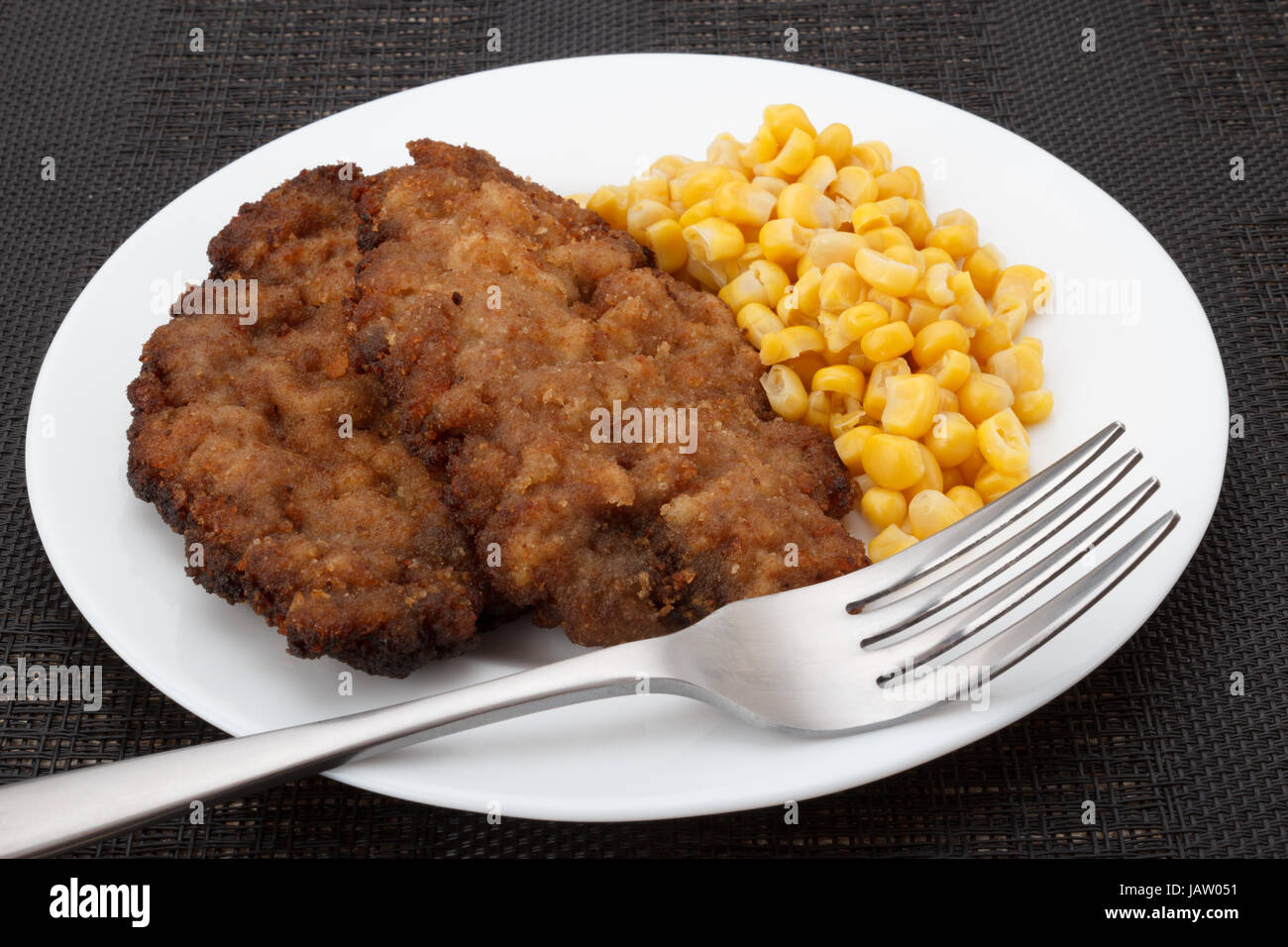 beef cutlets served with corn Stock Photo - Alamy