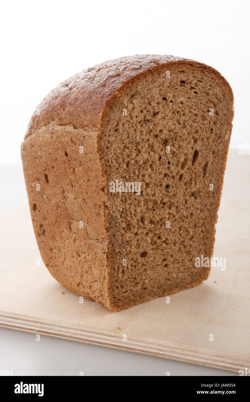 a half of rye bread loaf on a wooden chopping board surface Stock Photo ...