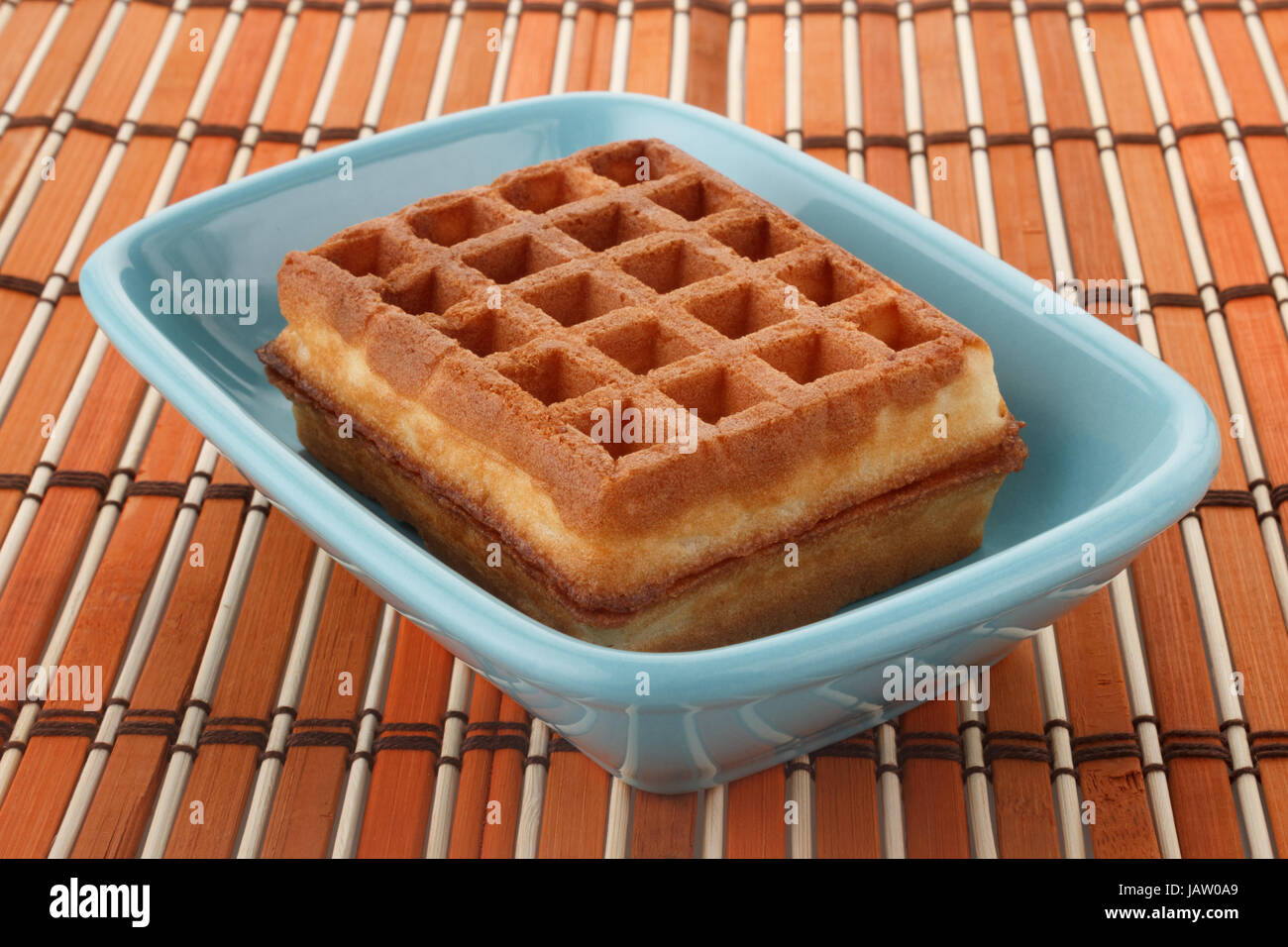 a belgian waffle in a blue container Stock Photo - Alamy