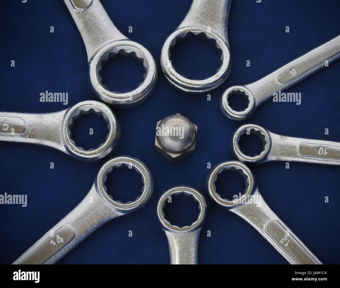 Circle of spanners surrounding a nut Stock Photo - Alamy