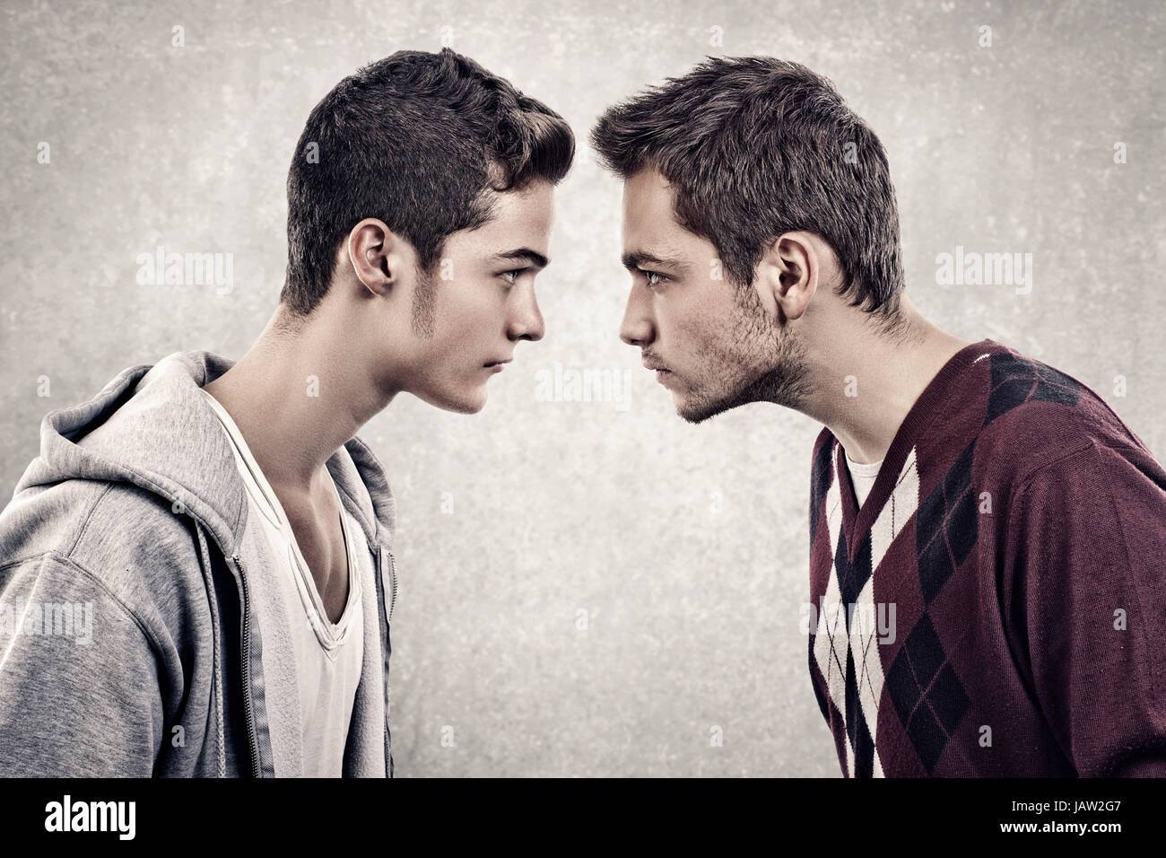 Two young angry people standing face to face Stock Photo - Alamy