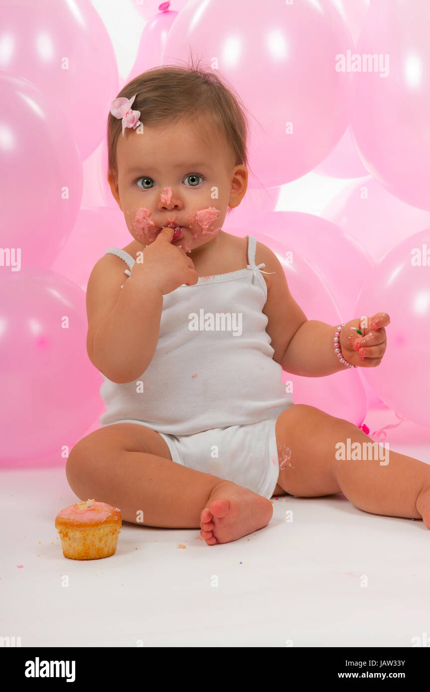 Birthday baby eating her birthday cupcake Stock Photo - Alamy