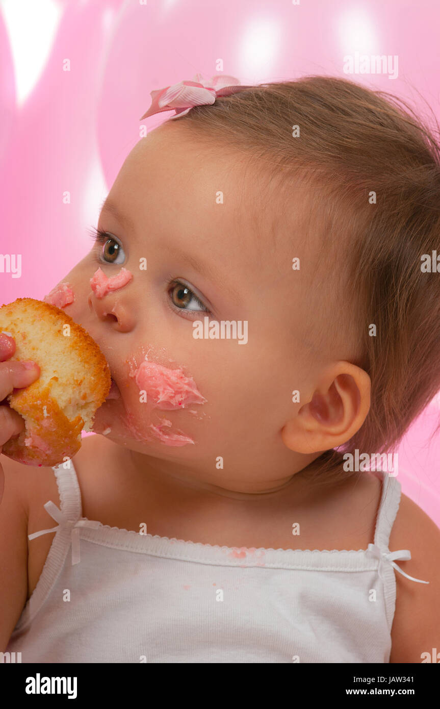 Birthday baby eating her birthday cupcake Stock Photo - Alamy