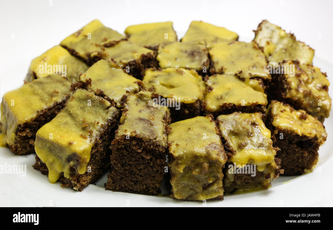 Pieces of cake with melting icing Stock Photo - Alamy